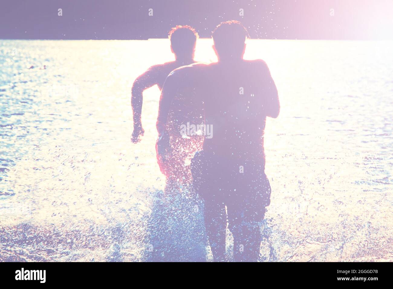 Group of young people playing games on sandy beach on a summer day ...