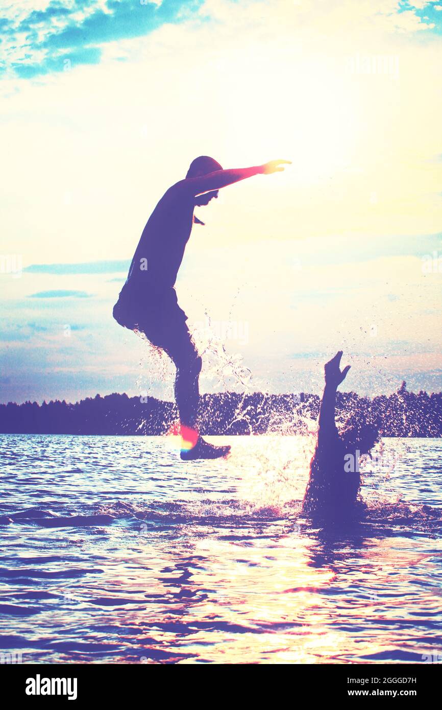 Group of young people playing games on sandy beach on a summer day ...