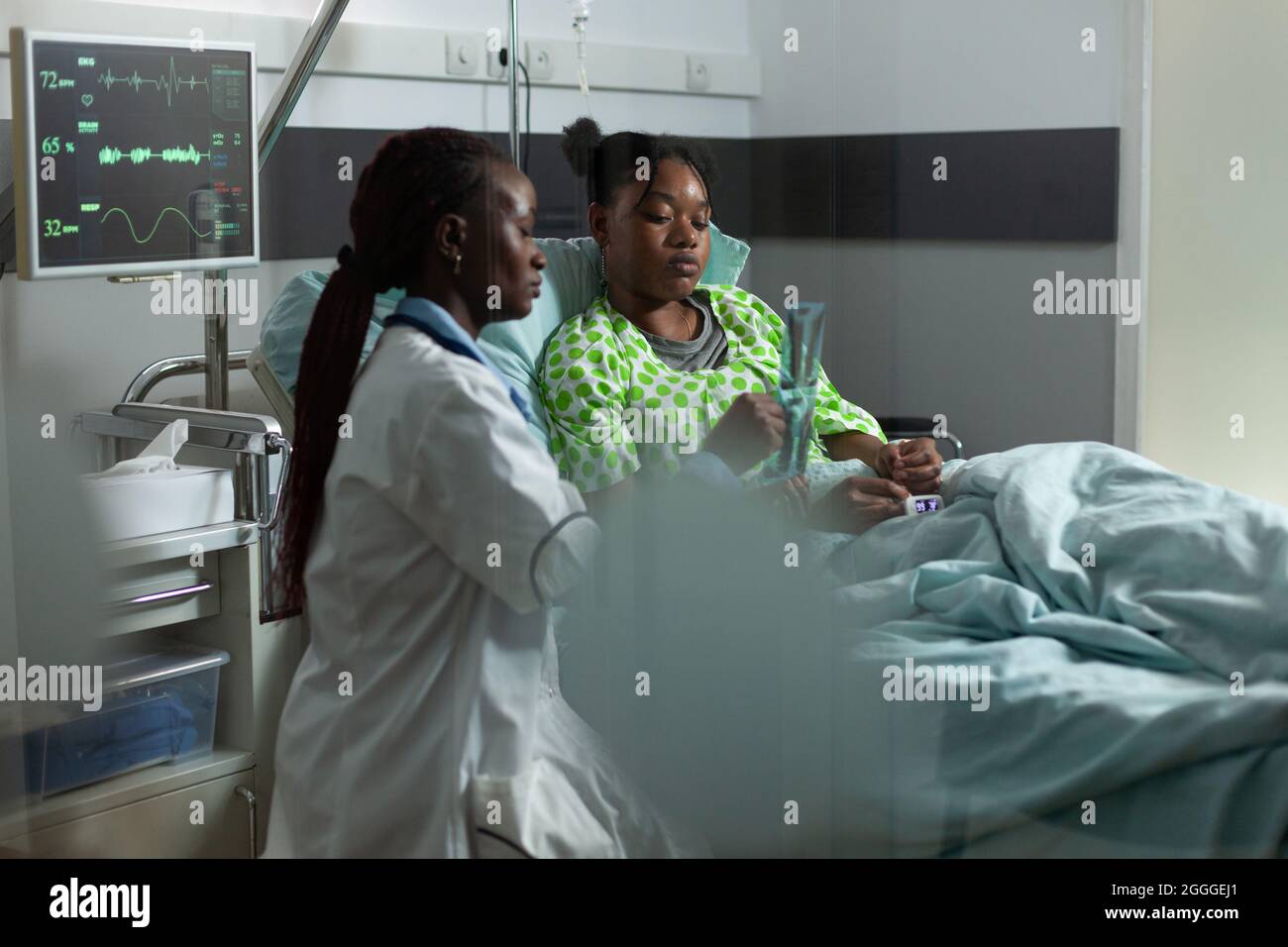African american medic analyzing x ray scan for diagnosis on patient ...