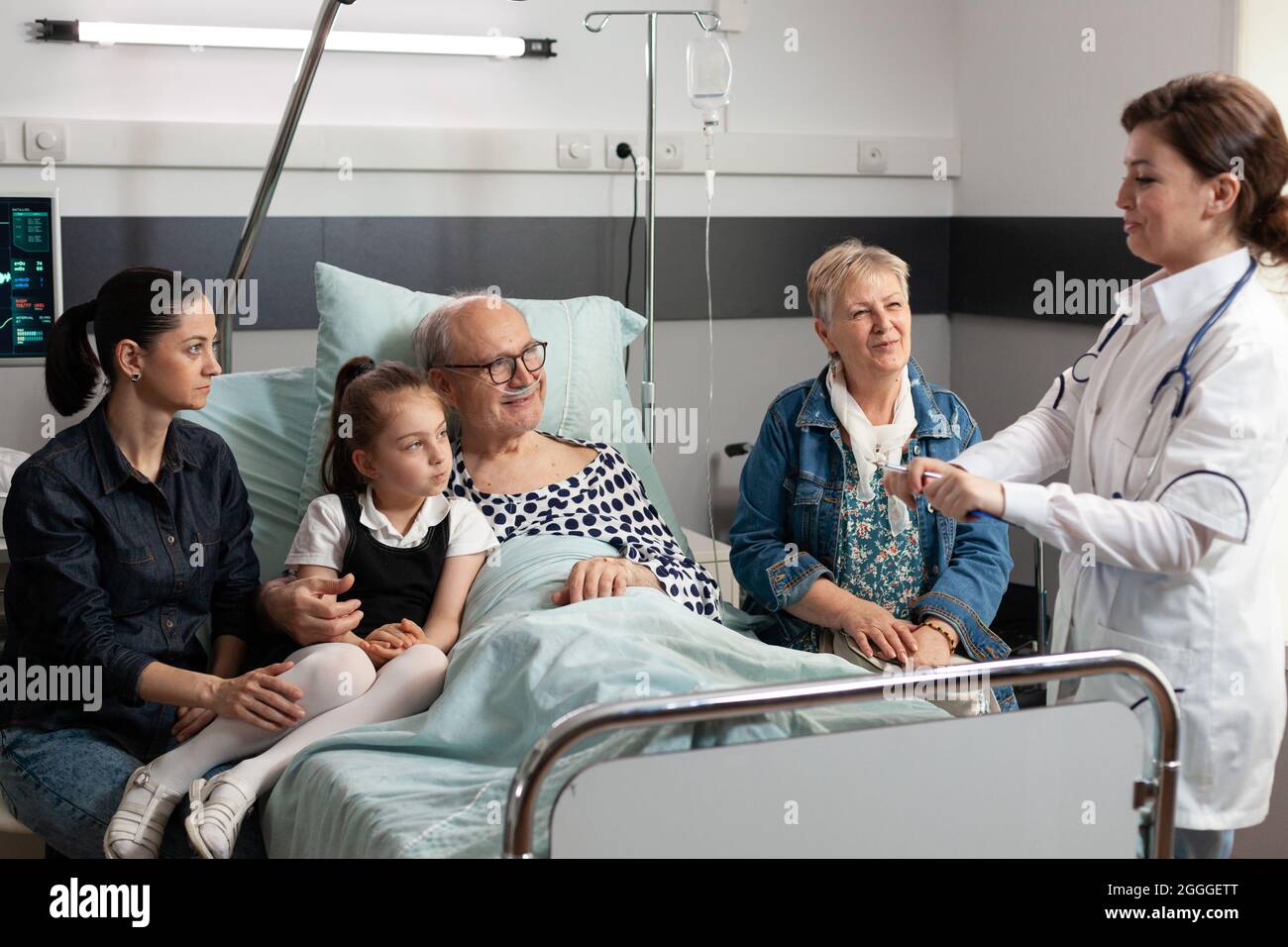 Practitioner doctor monitoring elderly sick old patient explaining ...