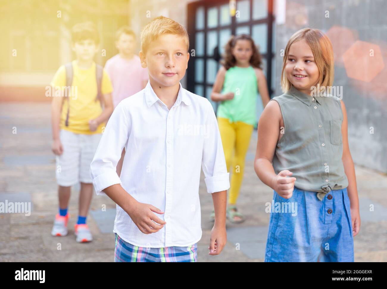 Girl and boy are walking city street Stock Photo - Alamy