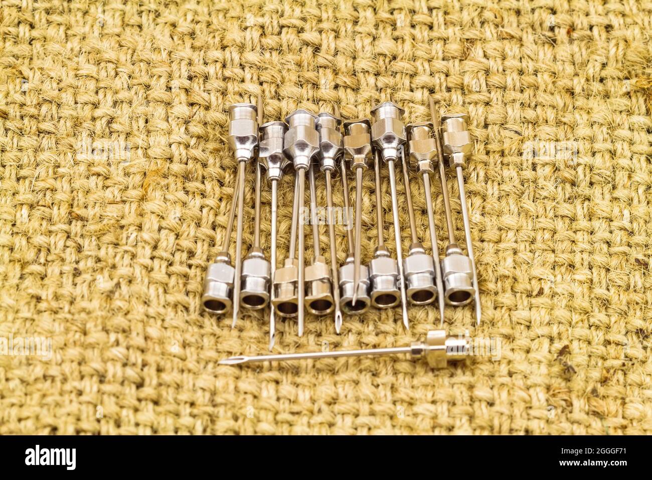 Stack of reuse iron needle No.18 G for drug needle on brown sack fabric ...
