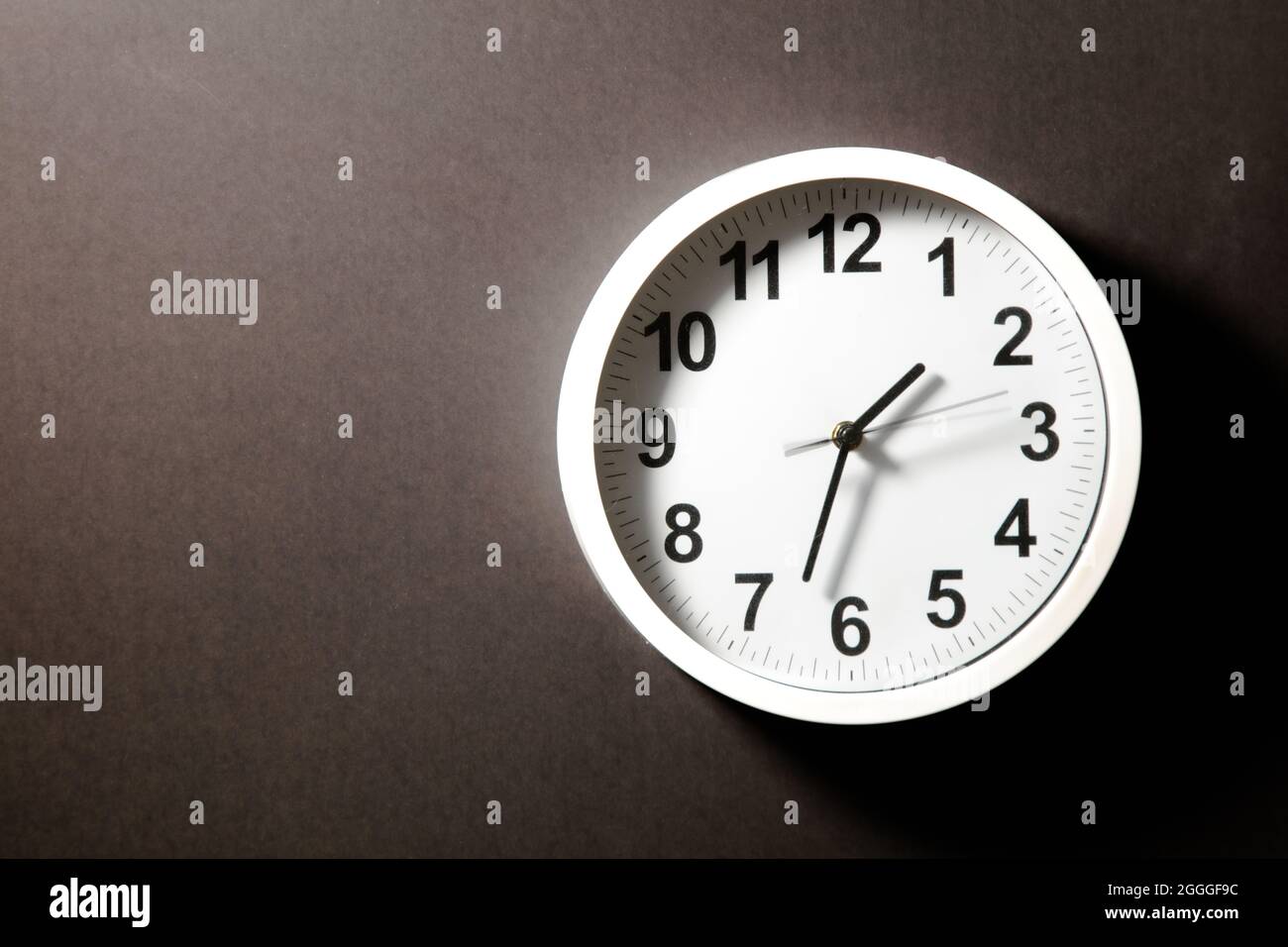 Modern white Wall Clock with black time pointer off center on black ...