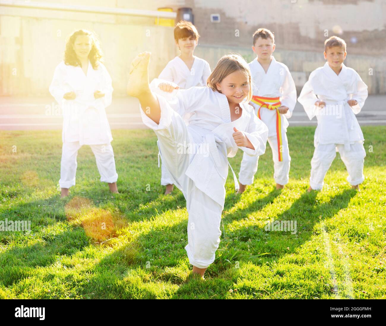 Preteen girl performing high kick during group taekwondo class Stock ...