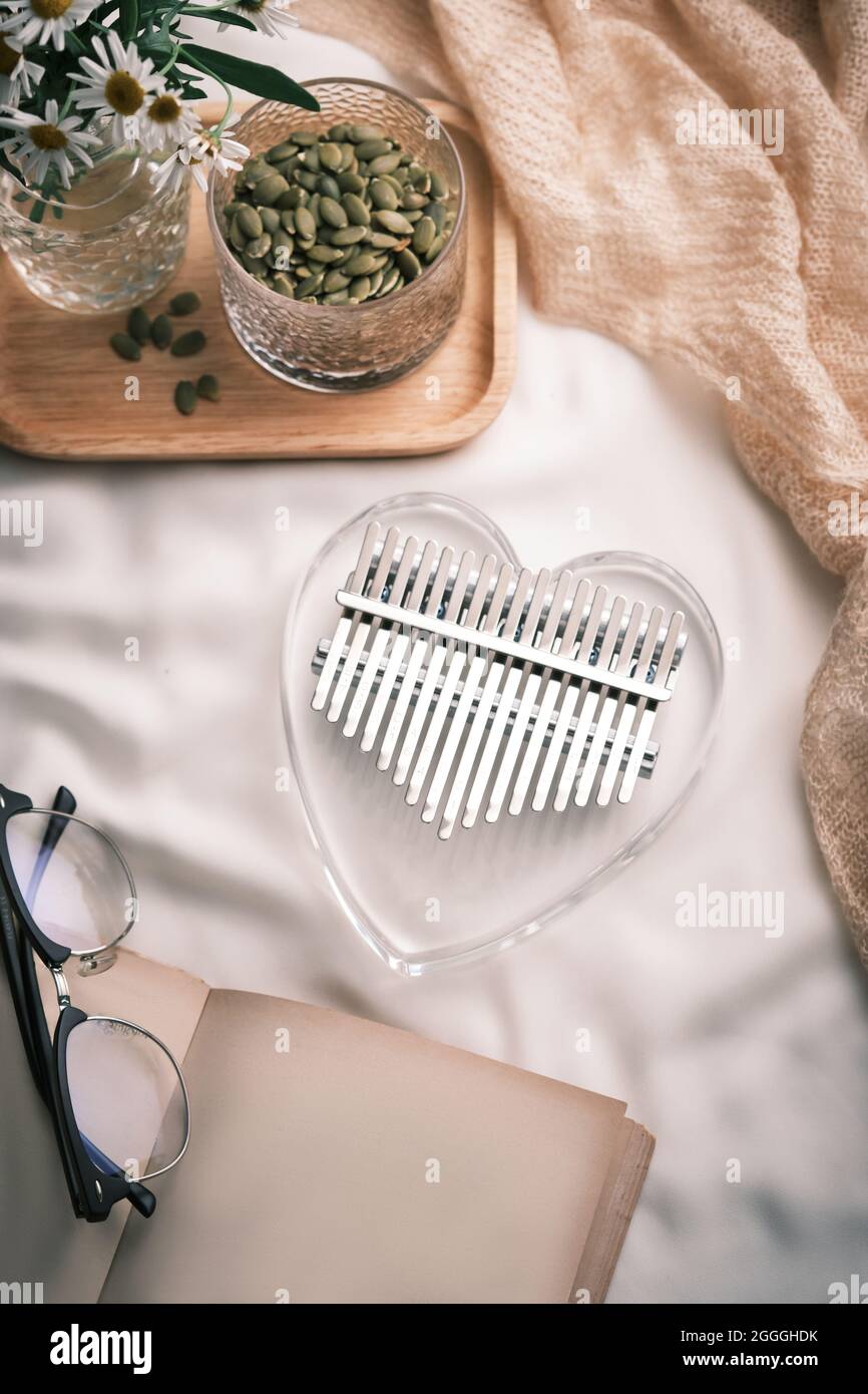 Kalimba or mbira is an African musical instrument on bed. Glass Kalimba ...