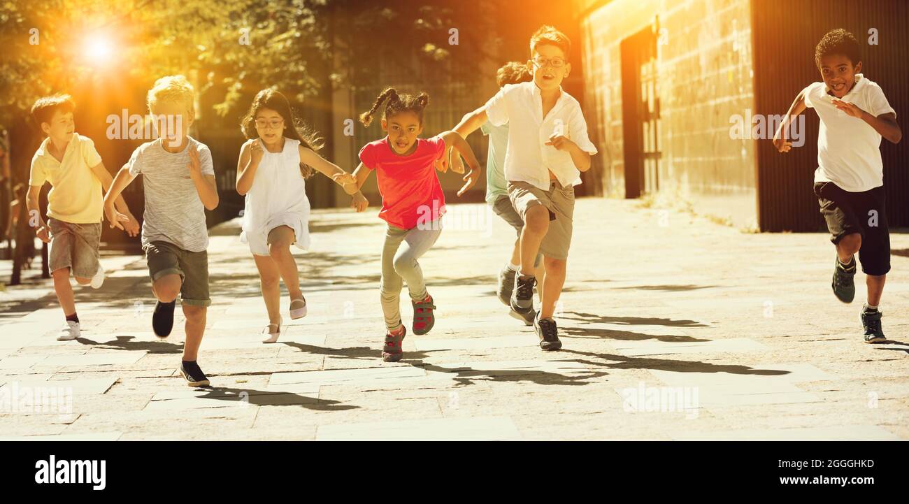 Happy kids running in race in the street and laughing outdoors Stock ...