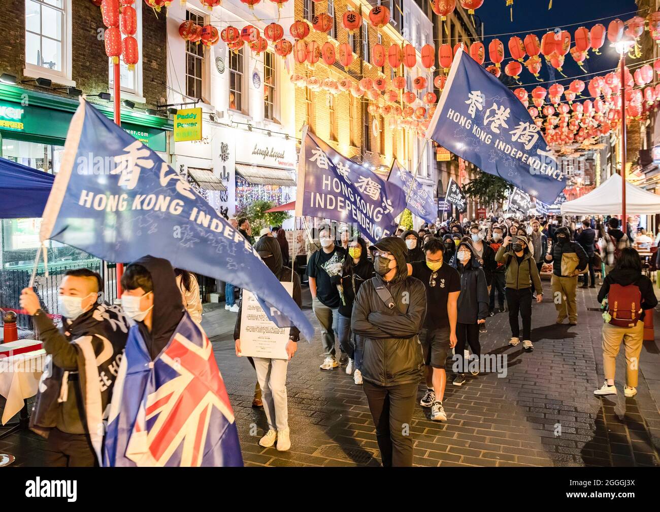 London, UK. 31st Aug, 2021. Pro-democracy protesters wave protest flags ...