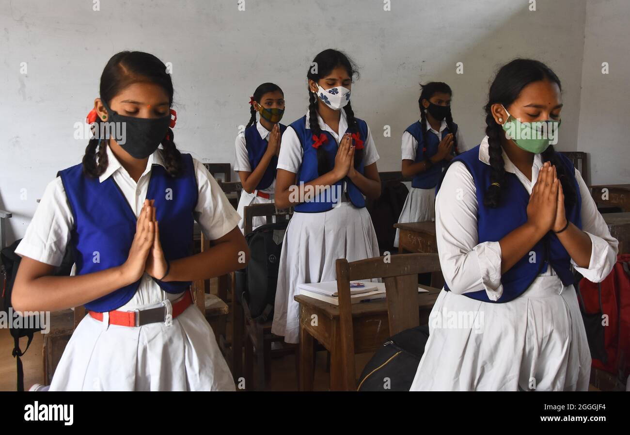 Students wearing facemasks maintain social distance while attending ...
