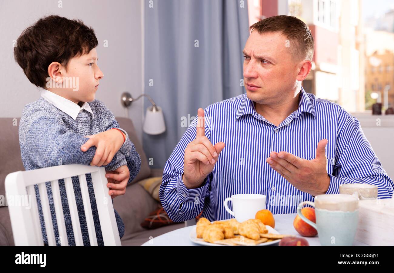 Troubled dad reprimanding son Stock Photo - Alamy