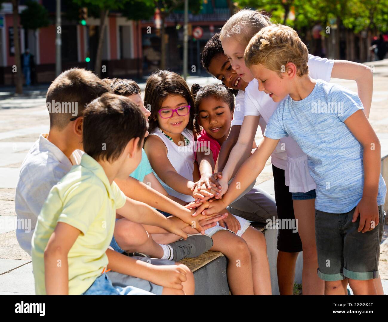Positive children holding hands and giving friendship vow Stock Photo ...