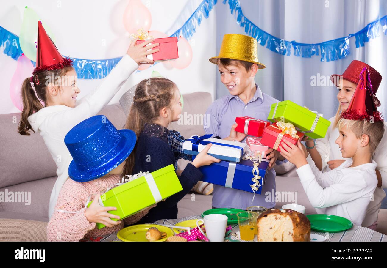 children giving presents to little boy during party Stock Photo - Alamy
