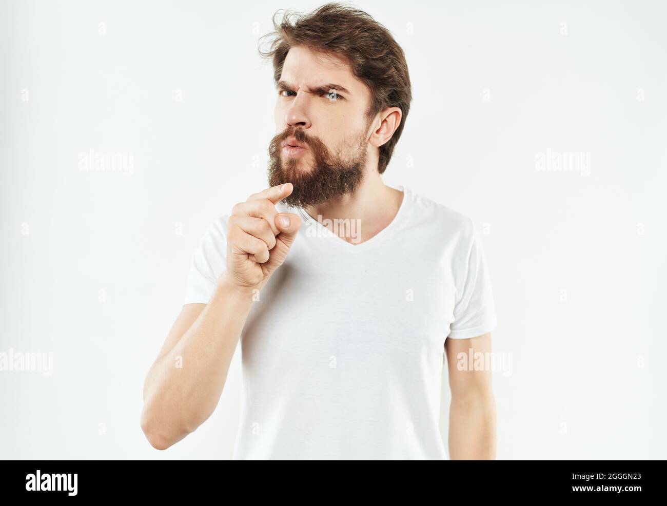 emotional man in a white t-shirt hand gestures anger light background ...