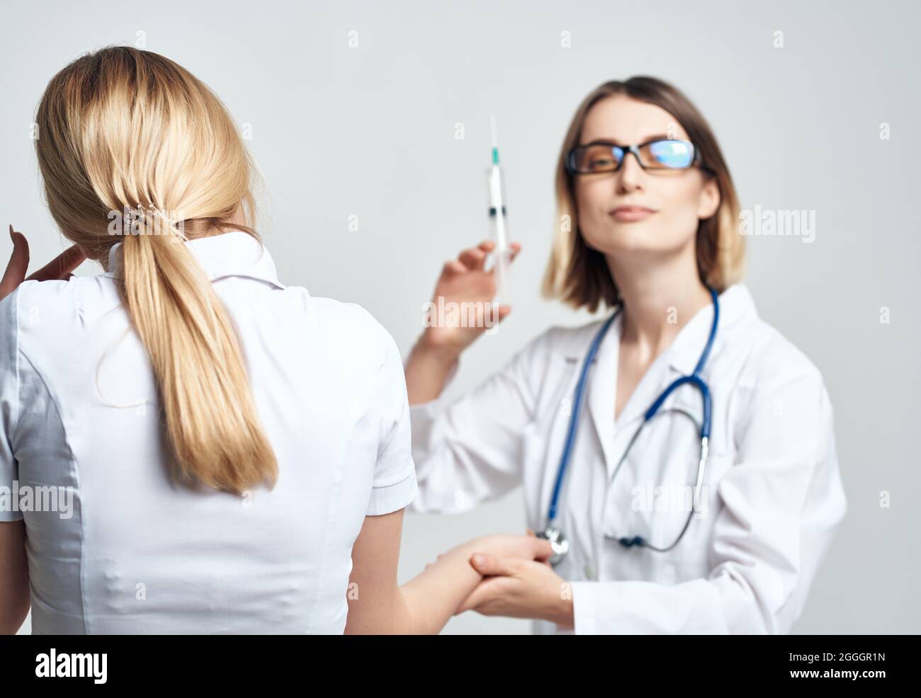 female doctor syringe in hand treatment Studio hospital Stock Photo - Alamy