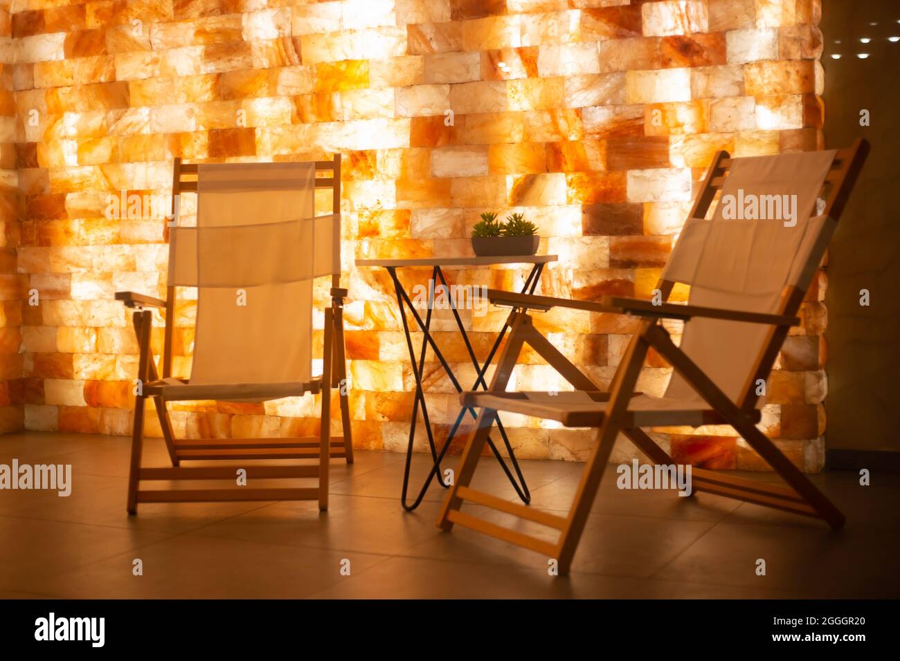 Salt room interior with armchairs and salt block wall in spa Stock ...