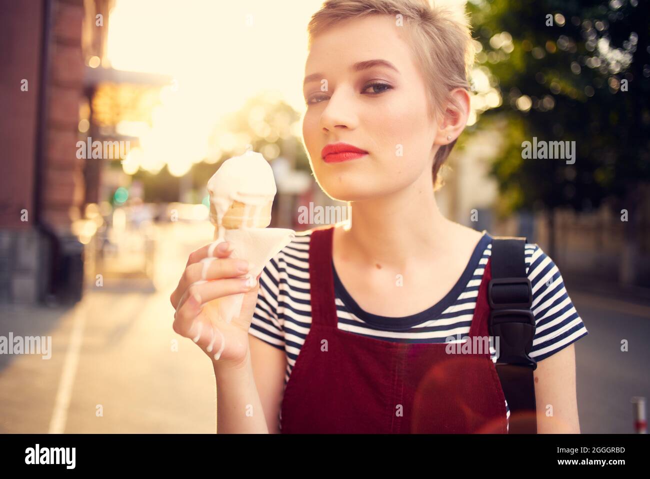 cheerful woman on the street eating ice cream walk summer Stock Photo ...