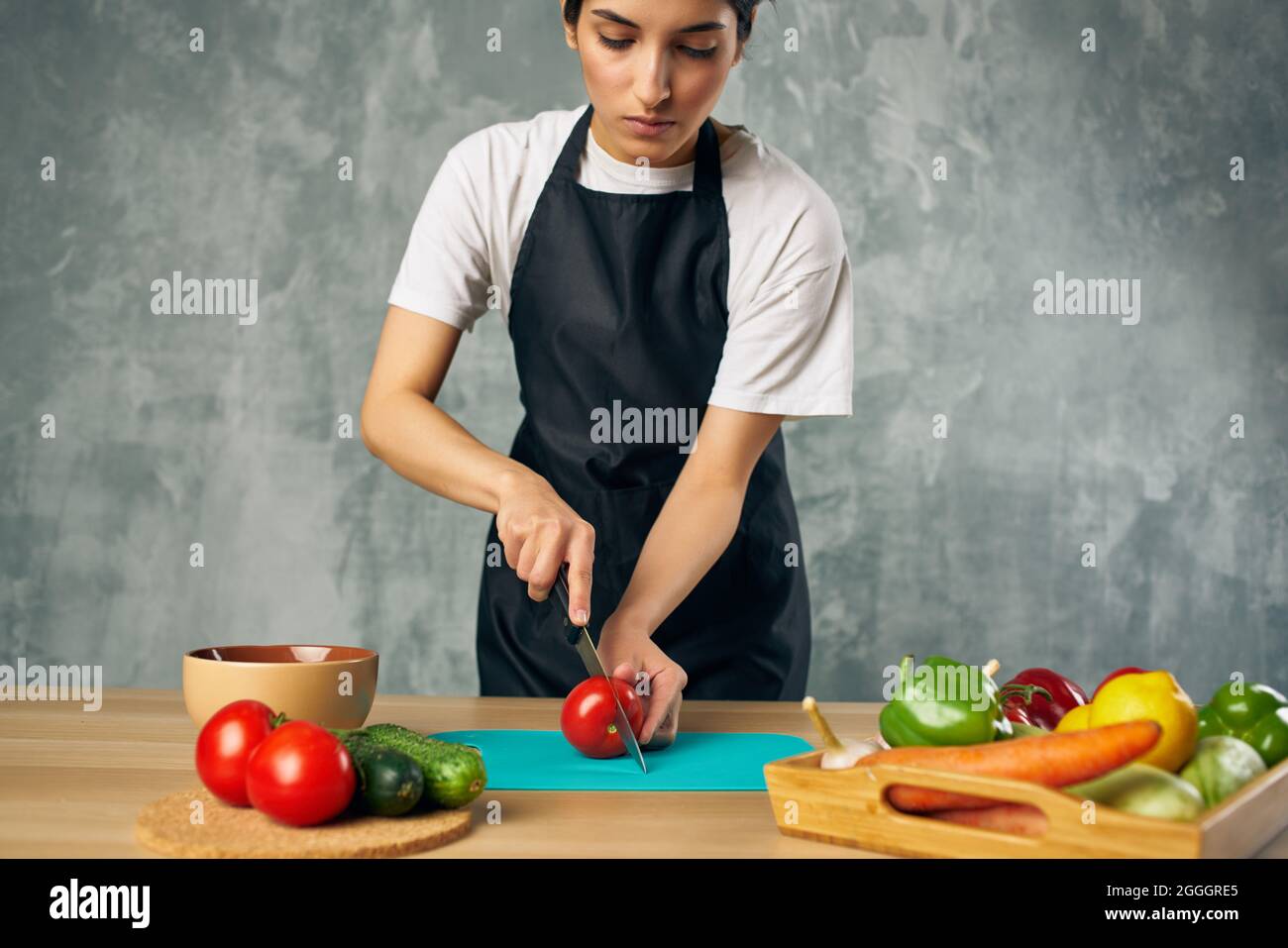 Cook in black apron Cooking healthy eating salad diet Stock Photo - Alamy