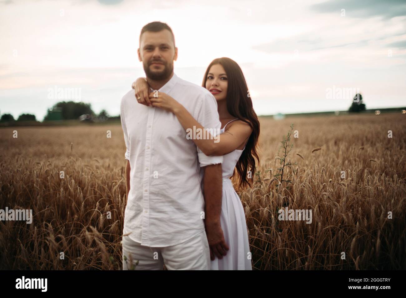 Loving couple in the field Stock Photo - Alamy