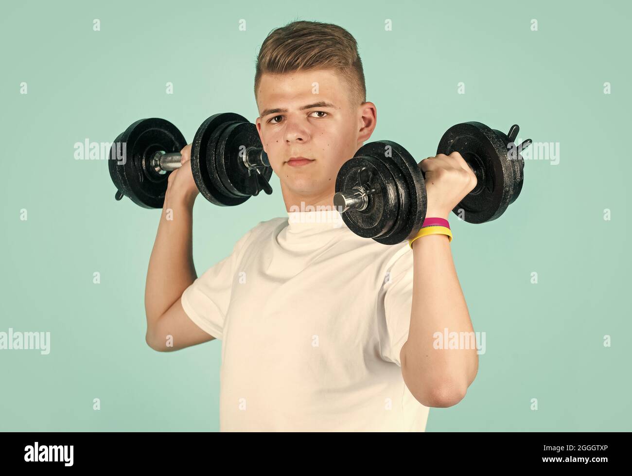he is strong. concept of fitness. child workout with dumbbell. power ...