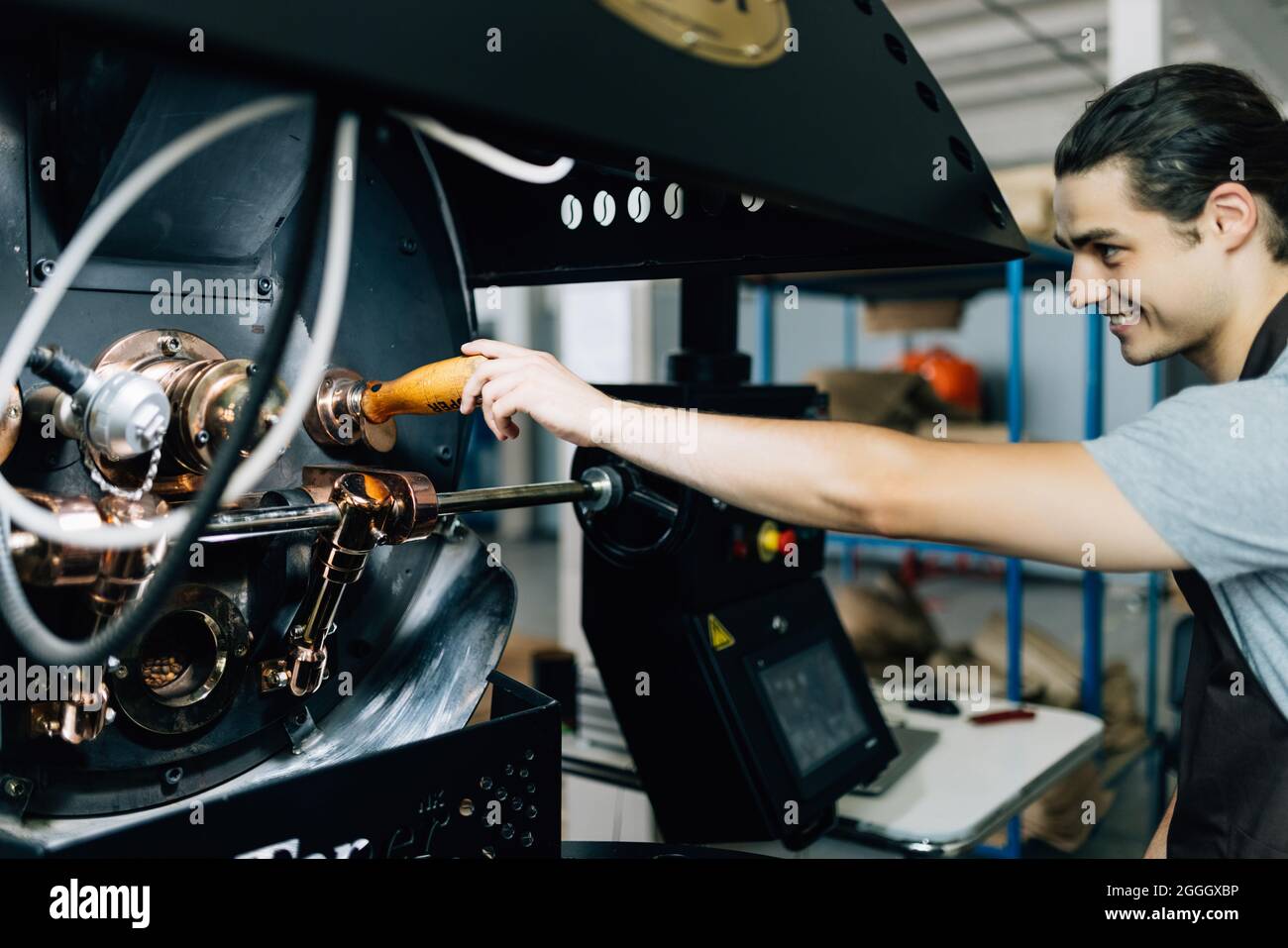Coffee shop owners show technology how to bake raw coffee beans in a ...