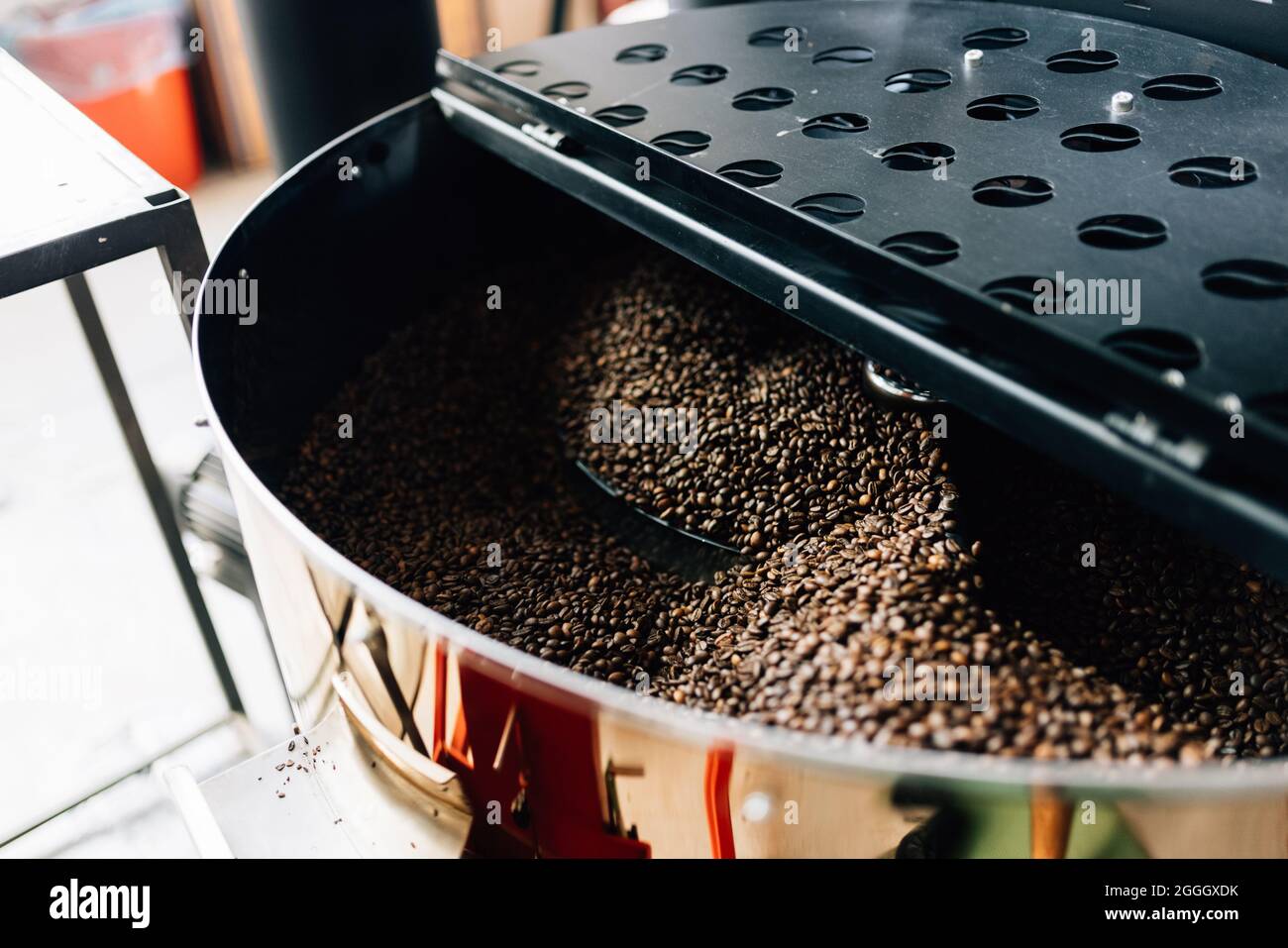 Baking coffee. Roasted Coffee beans before next step in professional ...