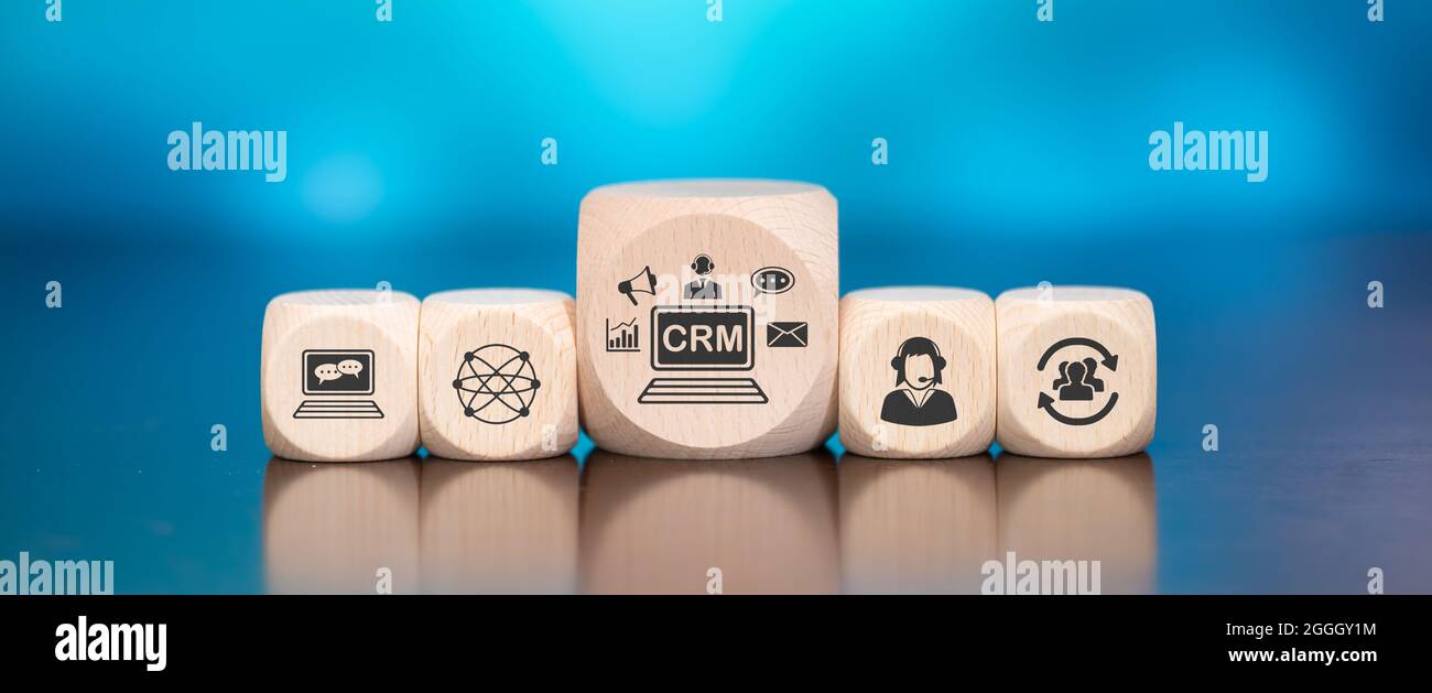 Wooden blocks with symbol of crm concept on blue background Stock Photo ...