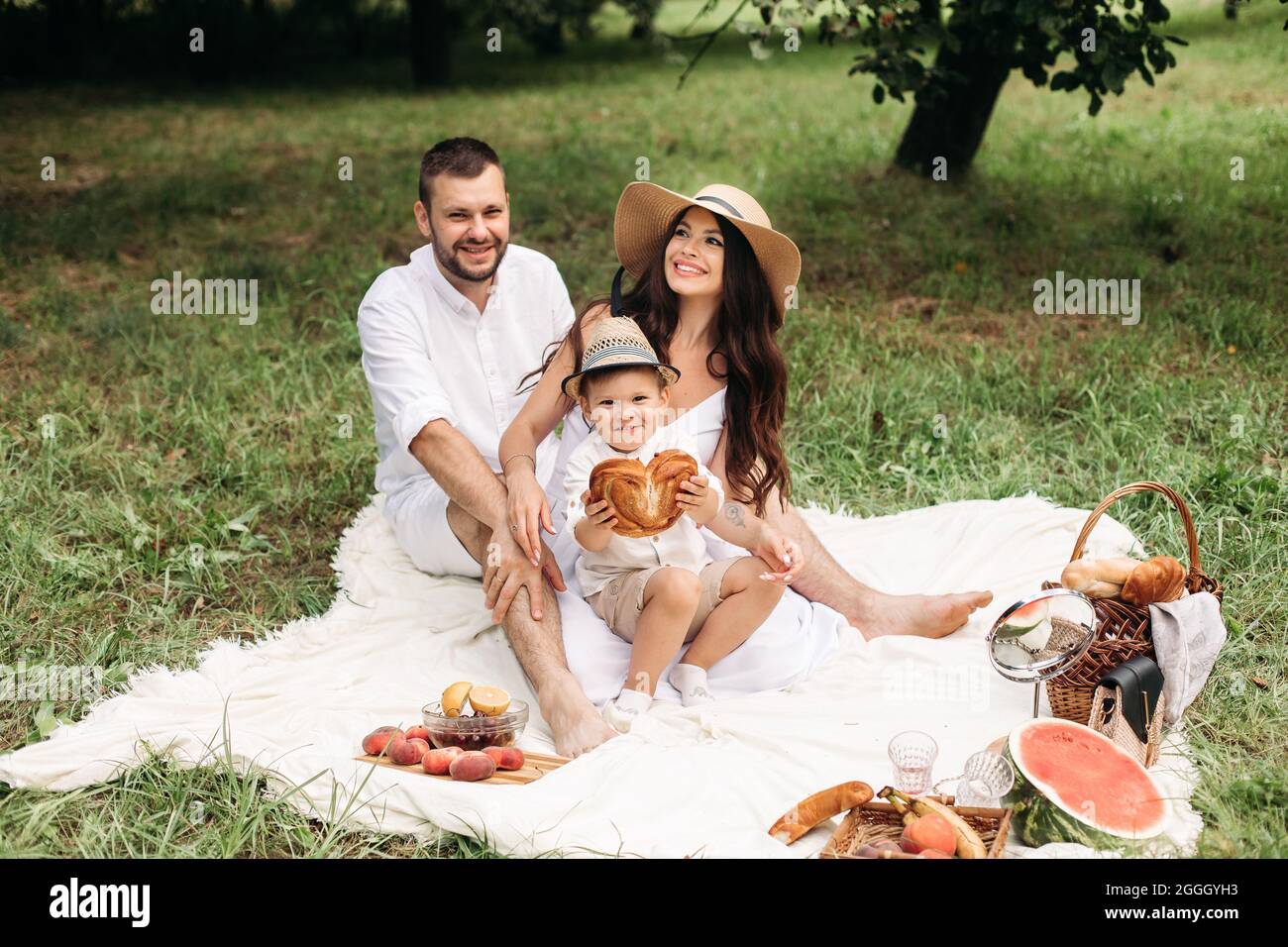 Beautiful mum, dad and their cute little child have fun together and ...