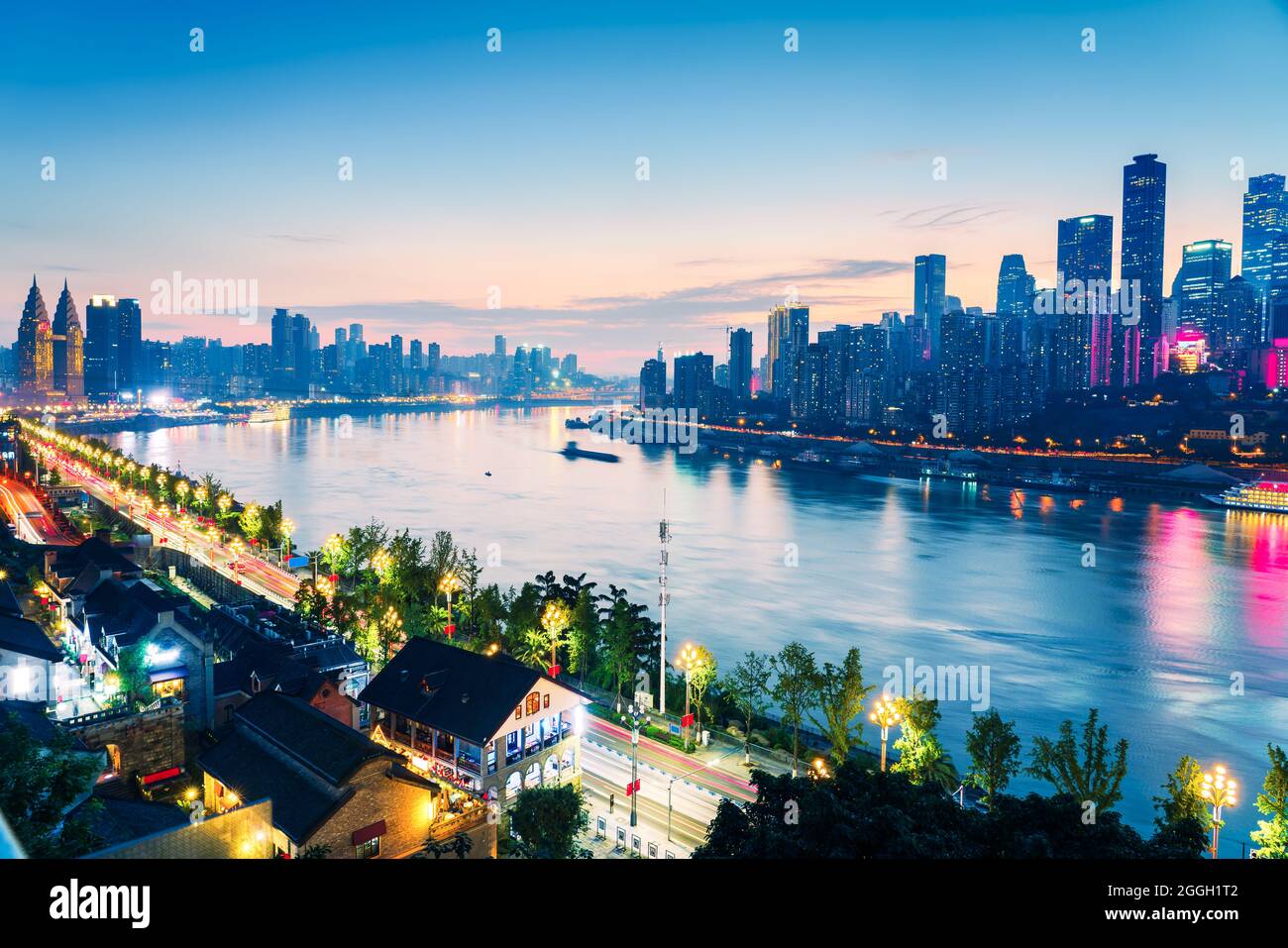 cityscape and skyline of downtown near water of chongqing at night ...
