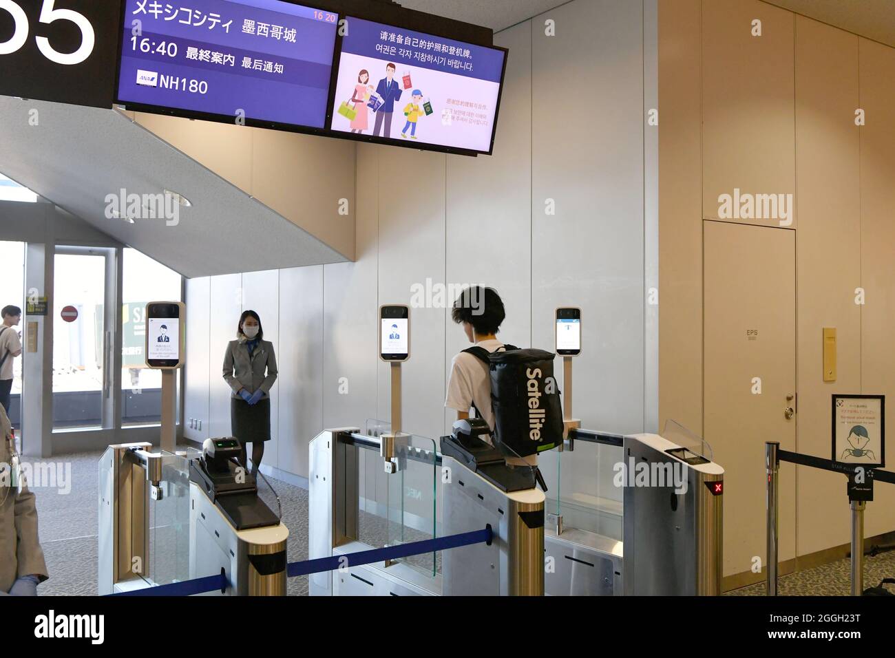 A passenger of ANA flight NH180 to Mexico City check-in using Face Express at the boarding gate ...