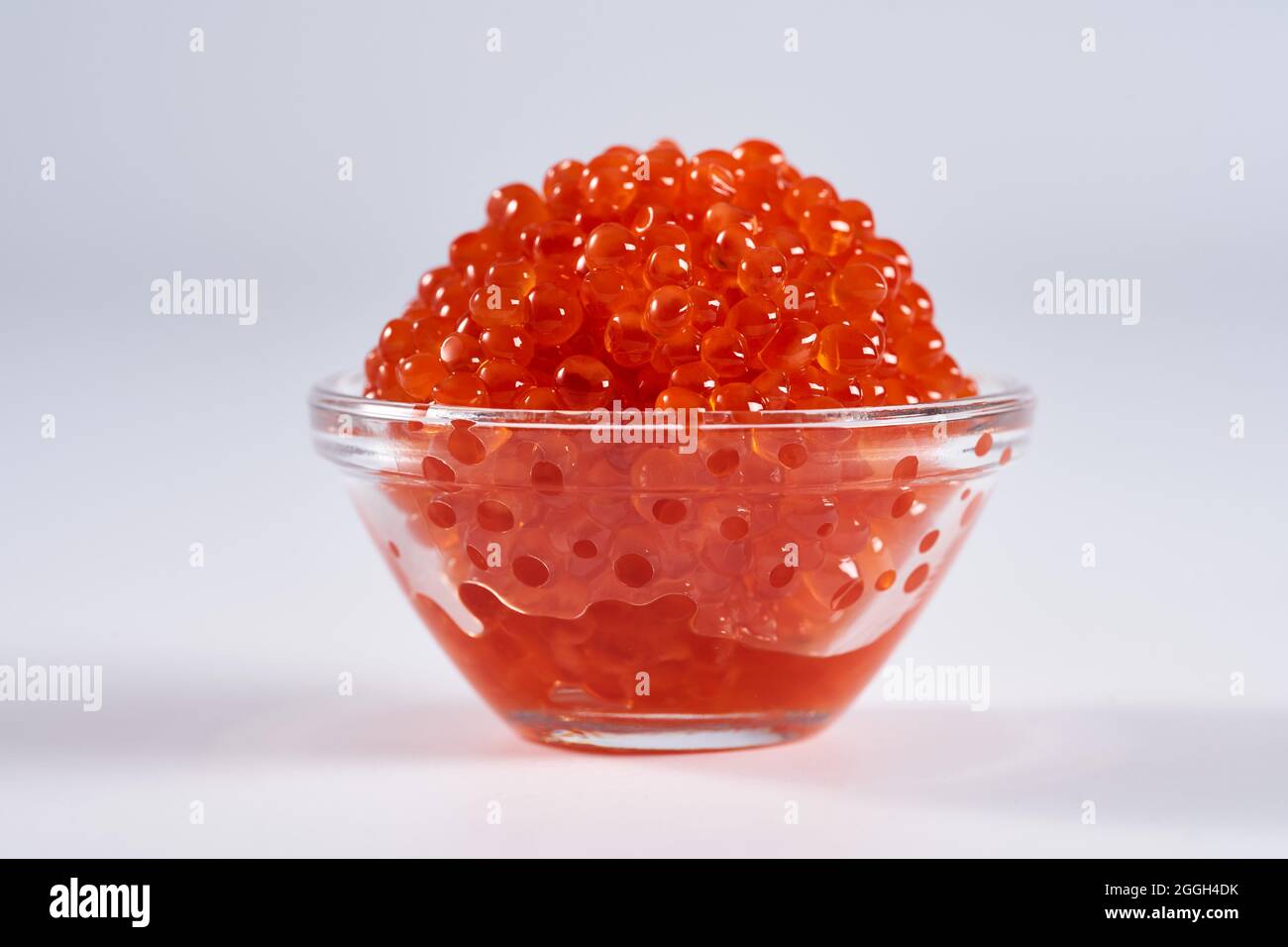 Red salmon roe in a little bowl over white background, isolated Stock ...