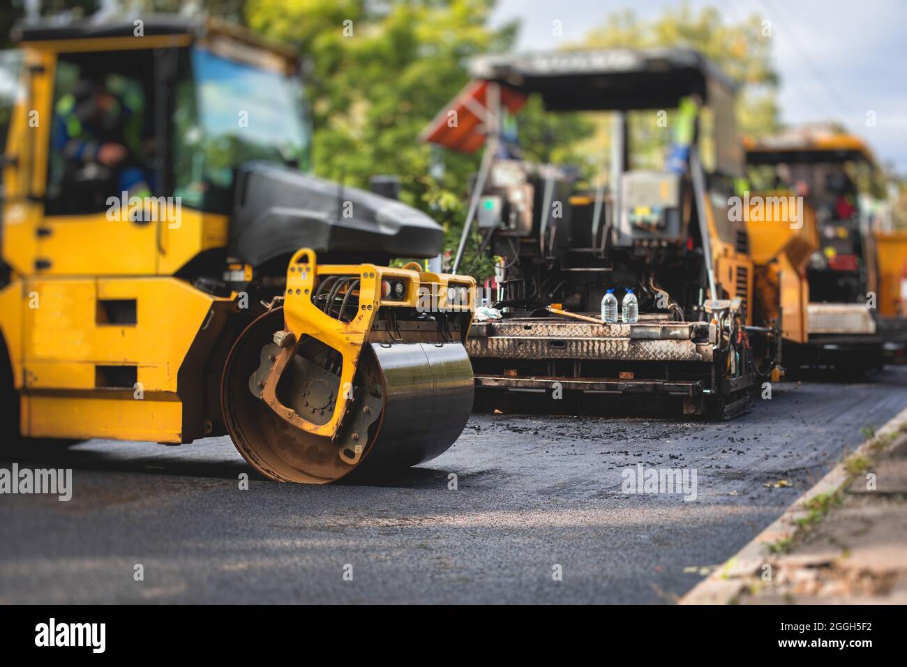 Process of asphalting, blacktopping and paving, asphalt paver machine ...