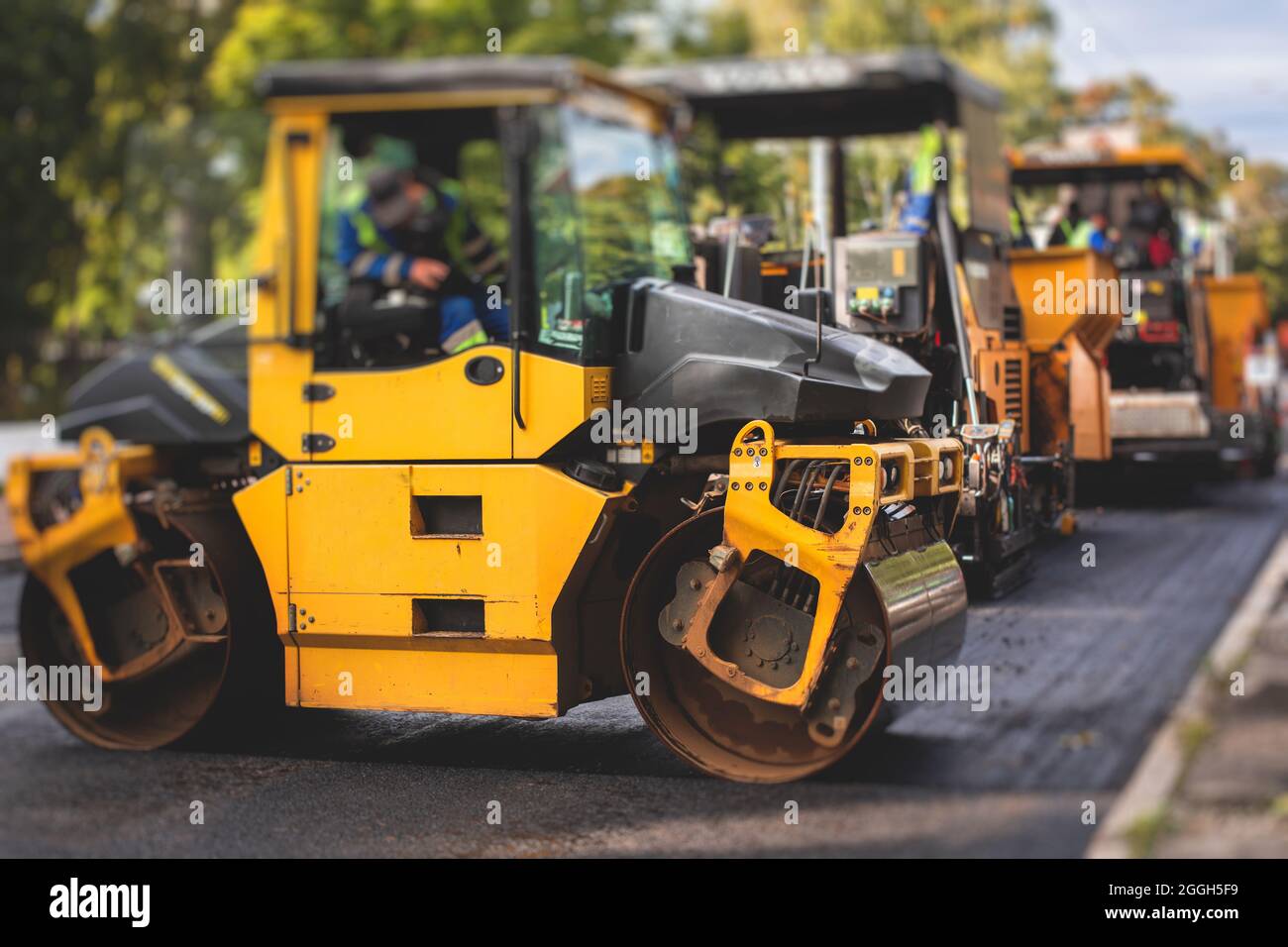 Process of asphalting, blacktopping and paving, asphalt paver machine ...