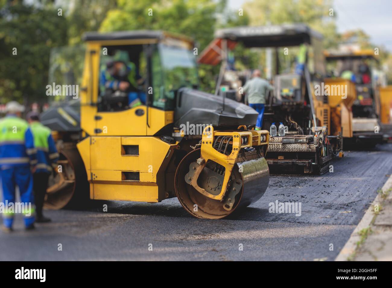 Process of asphalting, blacktopping and paving, asphalt paver machine ...