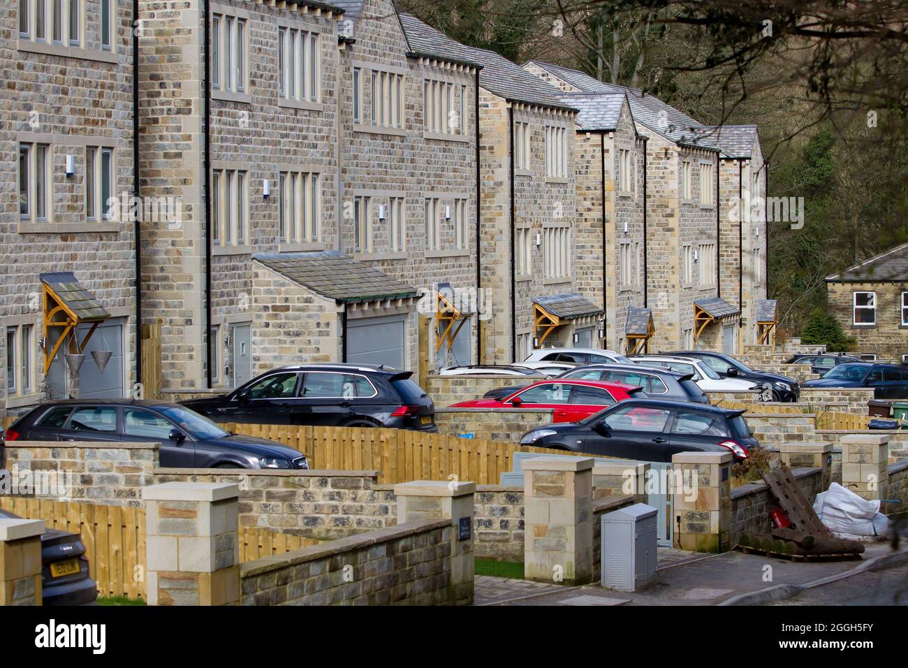 multiple cars parked outside a new housing development Stock Photo - Alamy