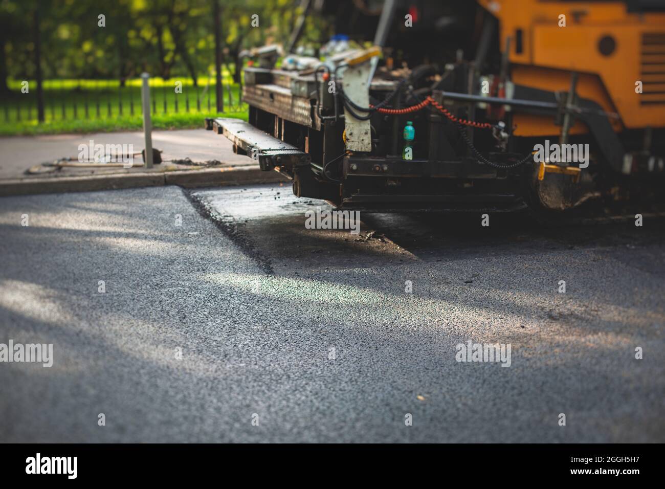 Process of asphalting, blacktopping and paving, asphalt paver machine ...