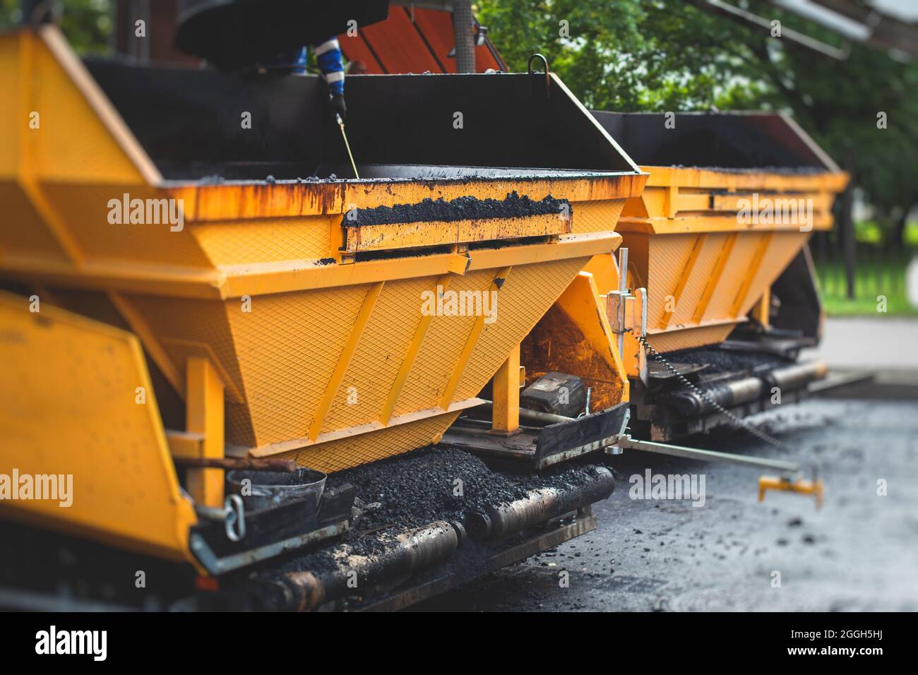 Process of asphalting, blacktopping and paving, asphalt paver machine ...