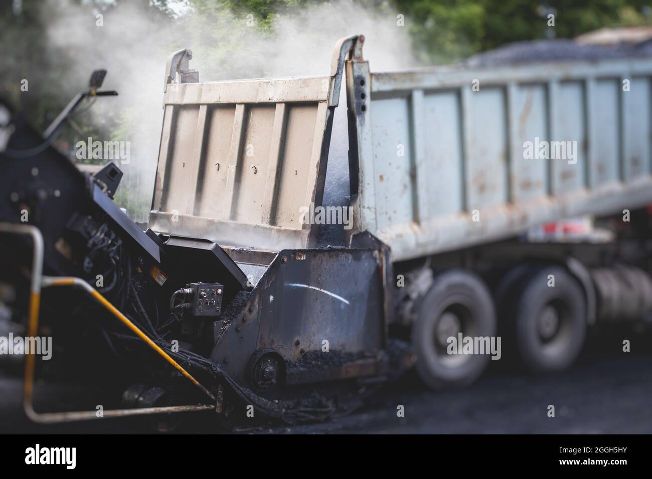 Process of asphalting, blacktopping and paving, asphalt paver machine ...