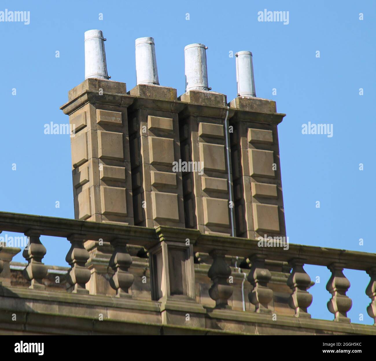 A Group of Four Chimneys on a Vintage Classic Building Stock Photo - Alamy