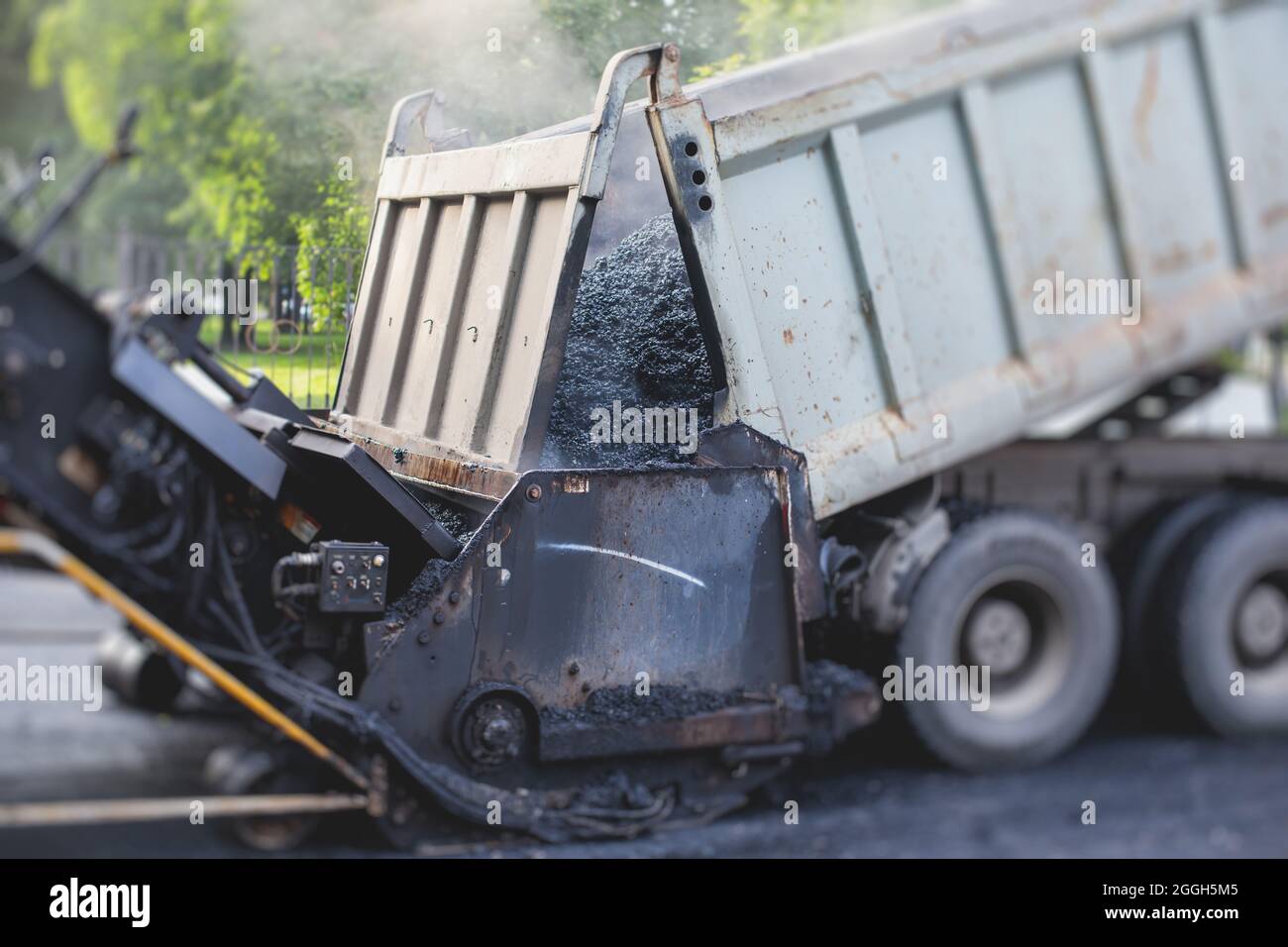 Process of asphalting, blacktopping and paving, asphalt paver machine ...