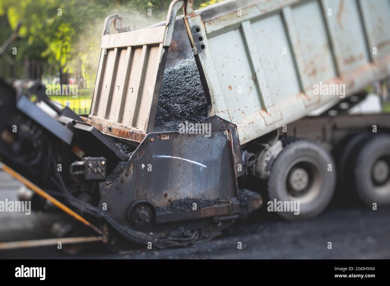 Process of asphalting, blacktopping and paving, asphalt paver machine ...