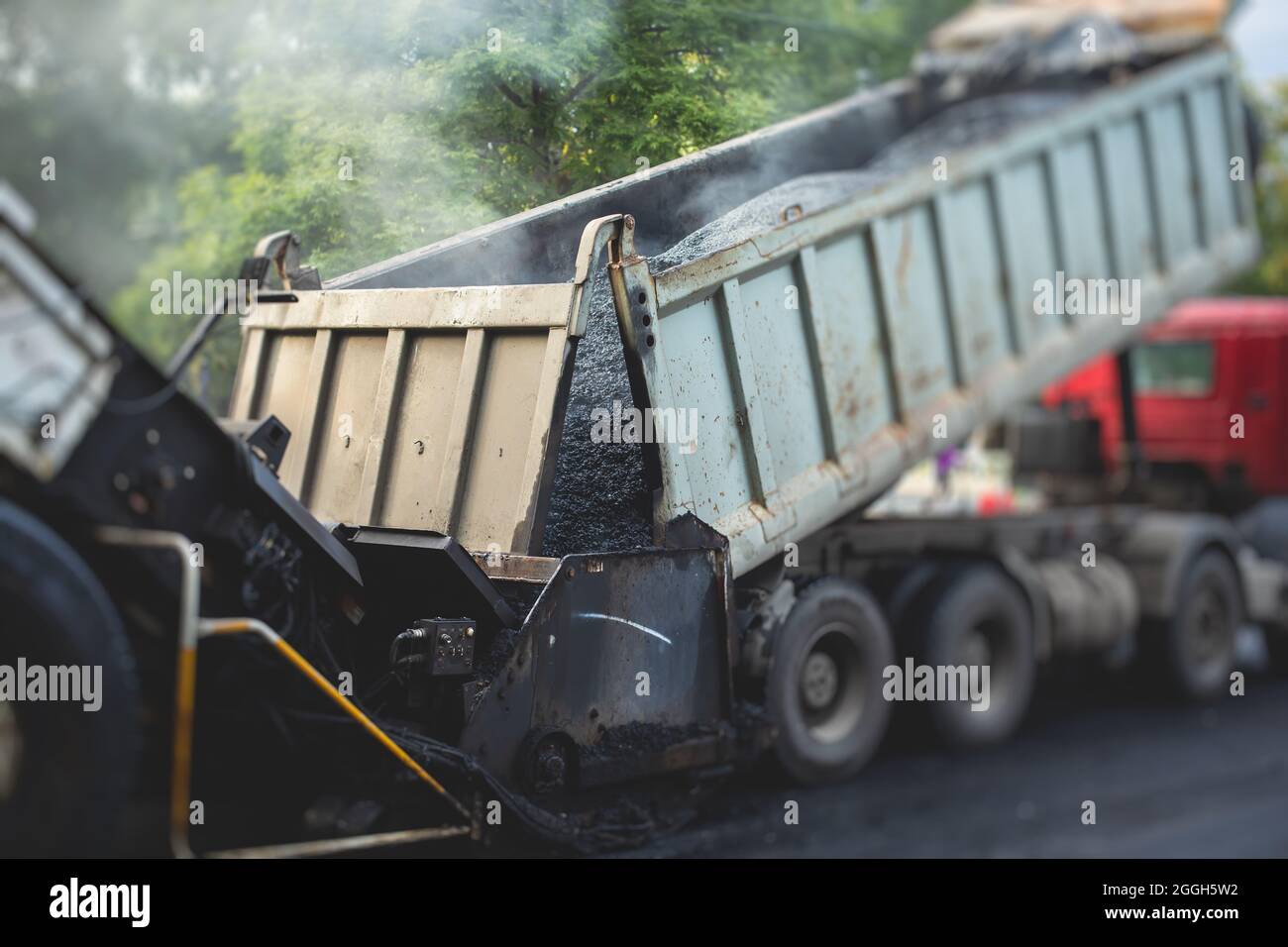 Process of asphalting, blacktopping and paving, asphalt paver machine ...