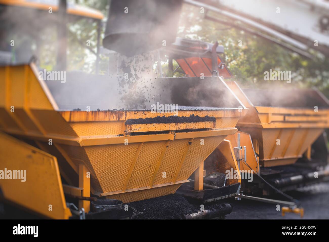 Process of asphalting, blacktopping and paving, asphalt paver machine ...