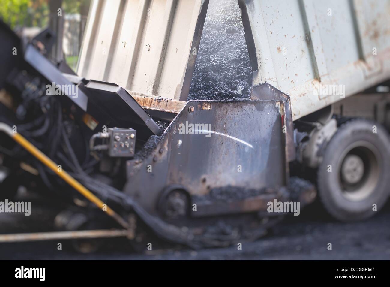 Process of asphalting, blacktopping and paving, asphalt paver machine ...