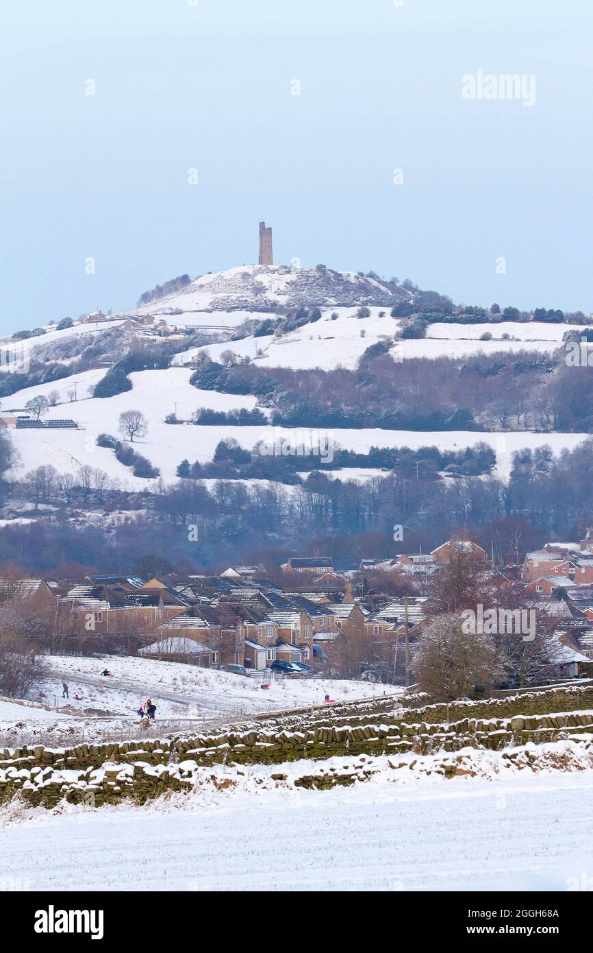 Castle Hill seen from Honley Village in the snow Stock Photo - Alamy