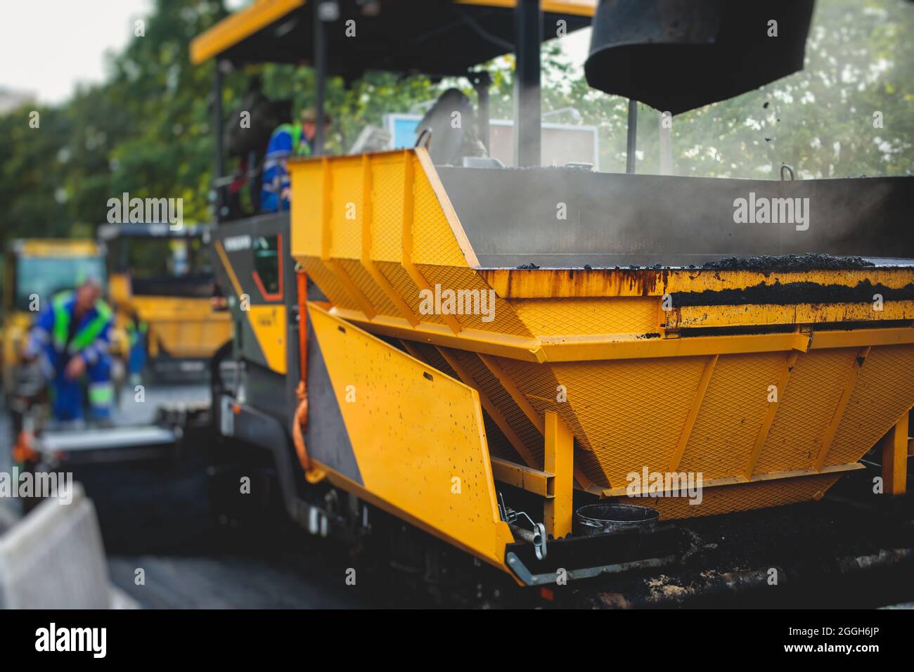 Process of asphalting, blacktopping and paving, asphalt paver machine ...