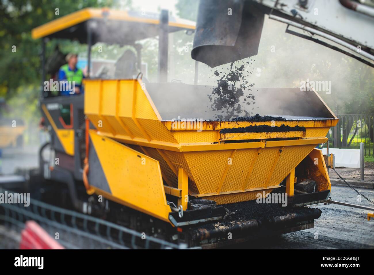 Process of asphalting, blacktopping and paving, asphalt paver machine ...
