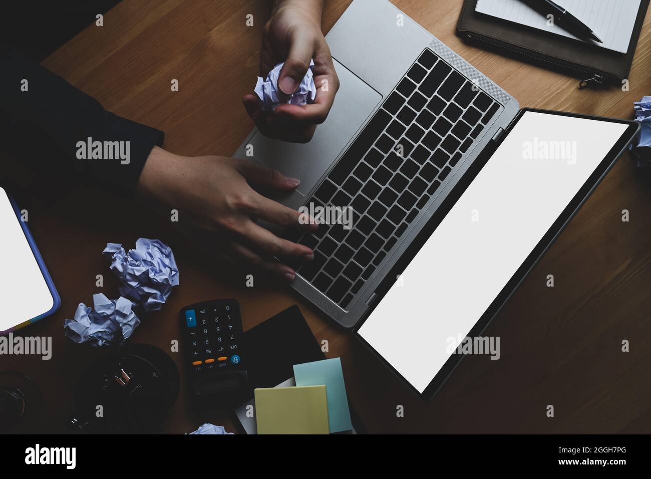 Stressed businessman crumpling paper at office desk Stock Photo - Alamy