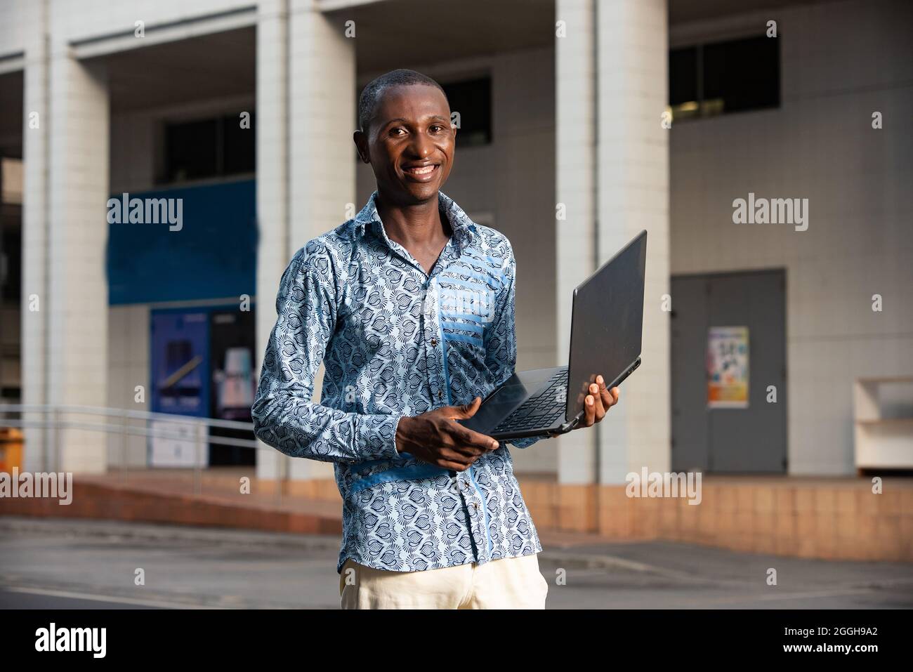 young african american man working standing up using a computer smiling ...