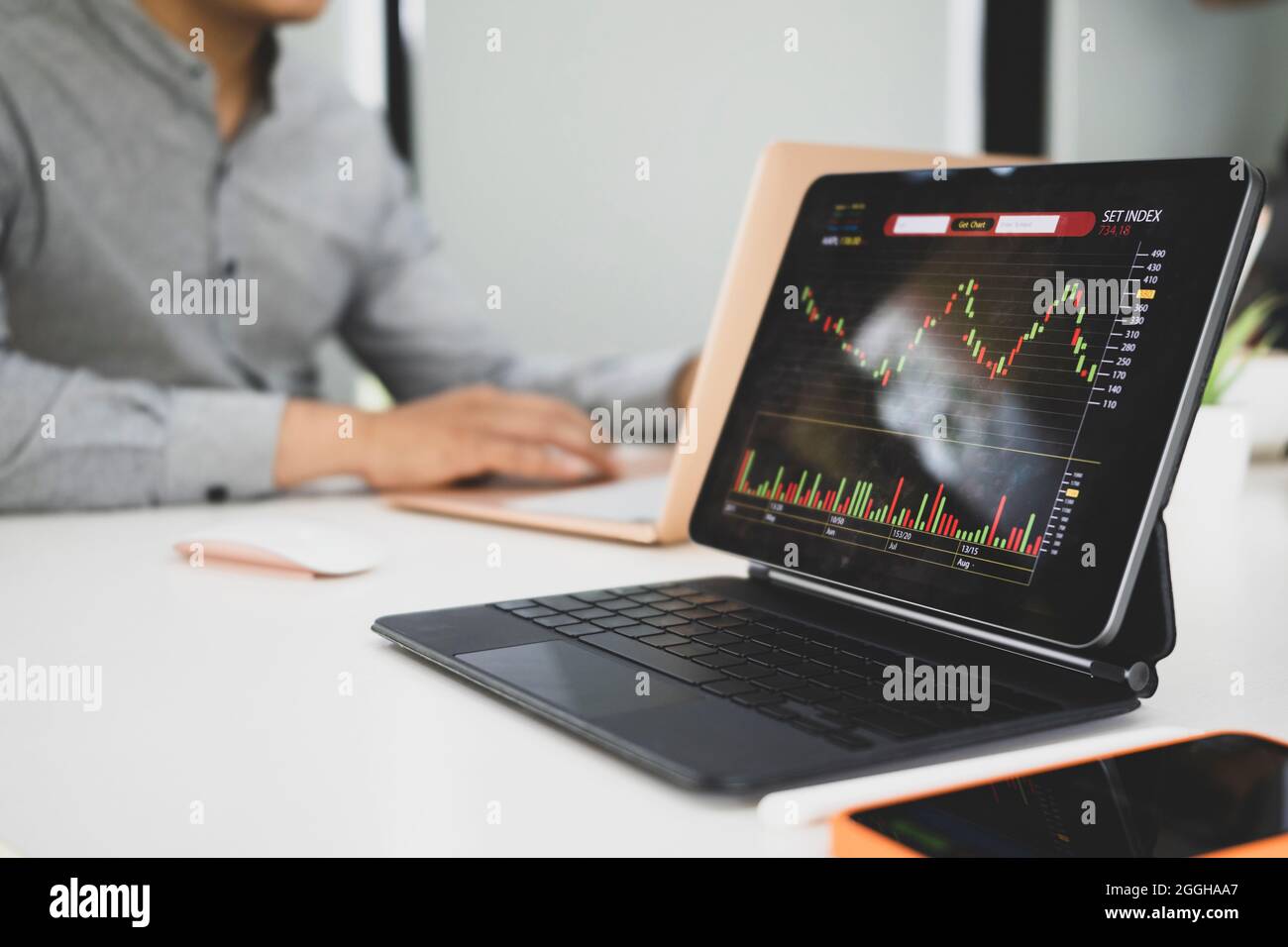 Statistics graphs on screen of computer tablet desktop Stock Photo - Alamy