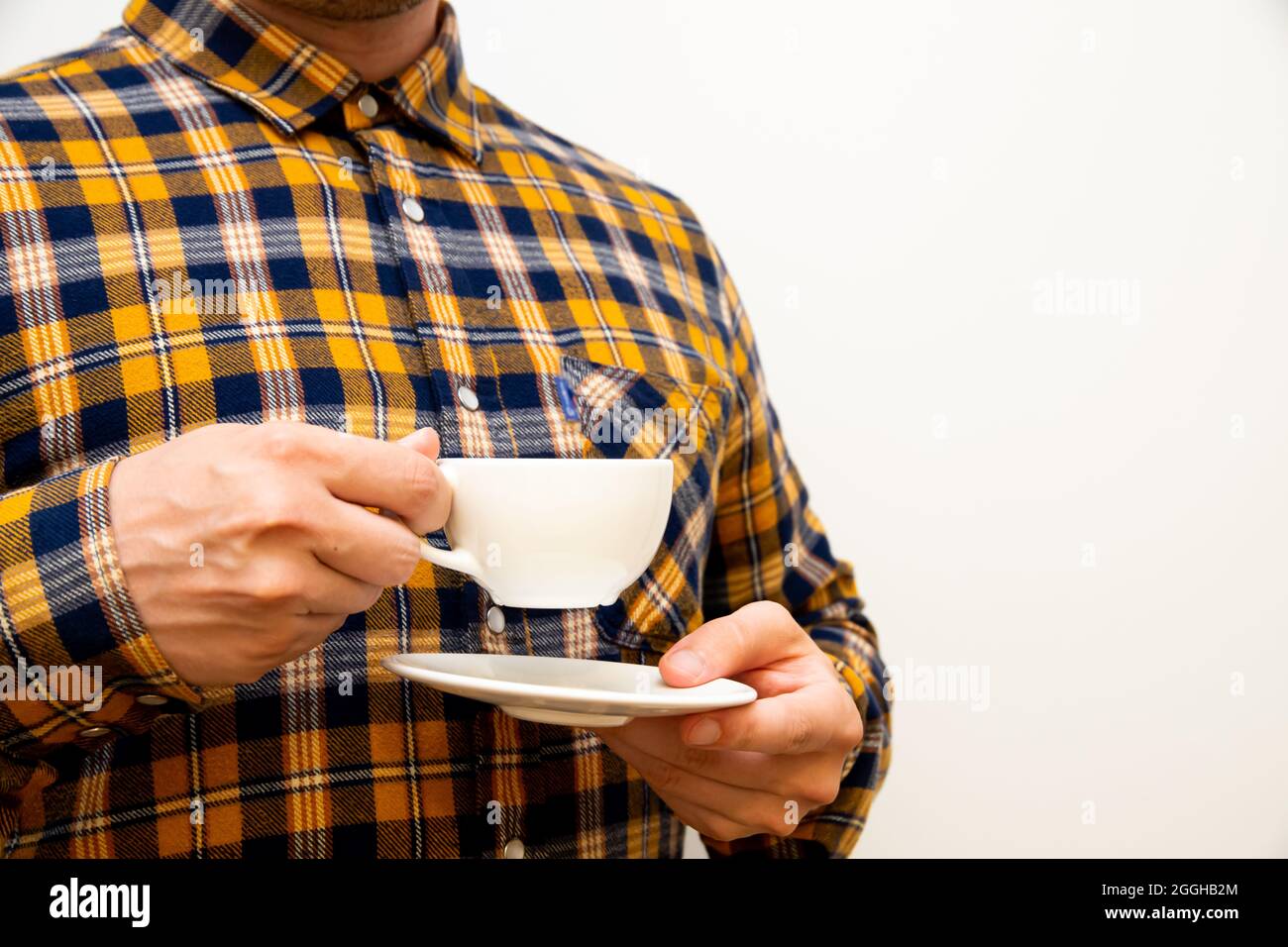 Man wearing flannel holding a cup of coffee isolated on white ...