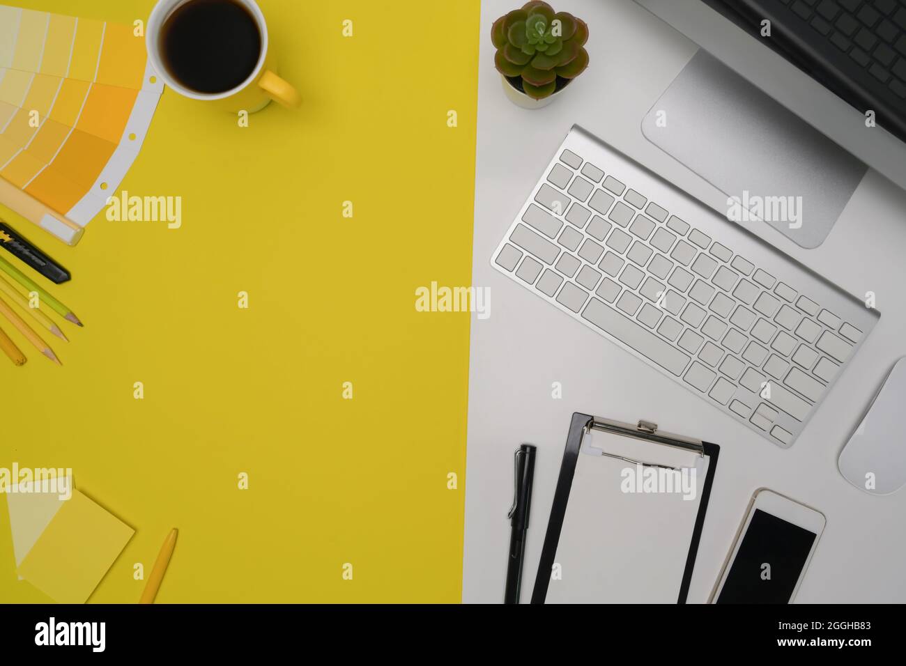 Creative workspace with computer, notepad, color swatches and coffee ...